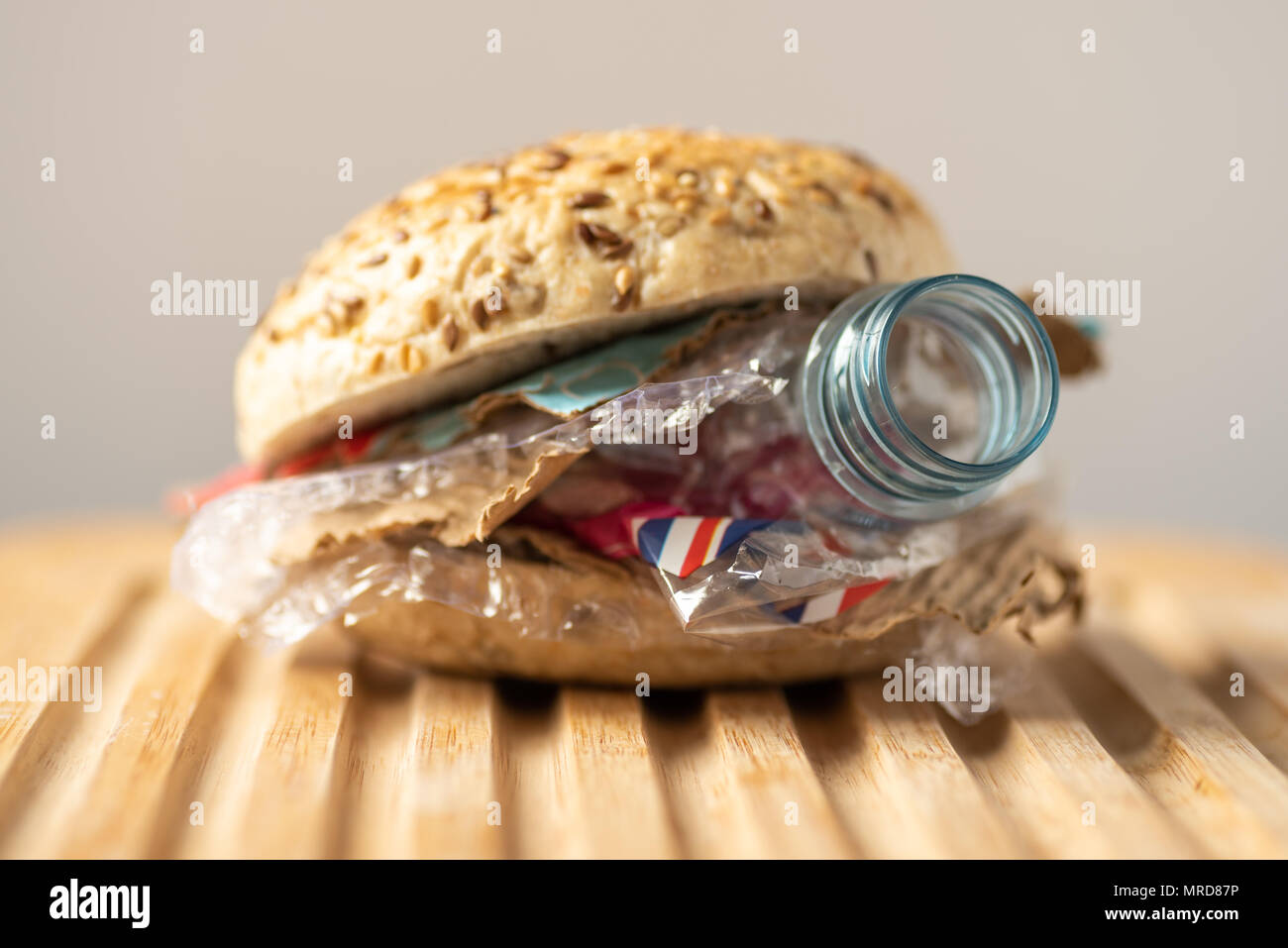 Fresh tasty burger with plastic waste and paper cardboard inside on ...