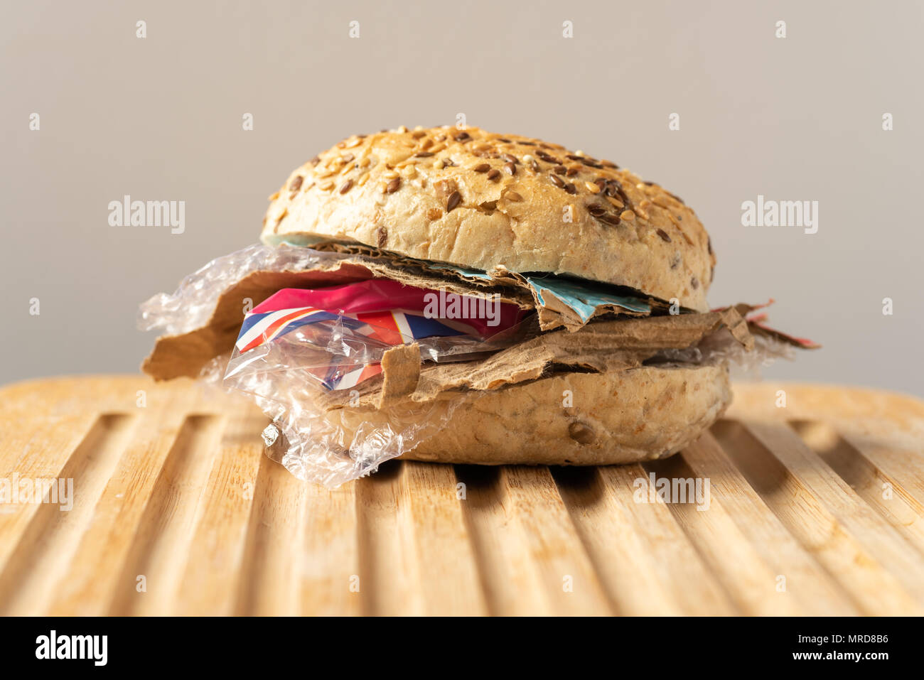 Fresh tasty burger with plastic waste and paper cardboard inside on ...
