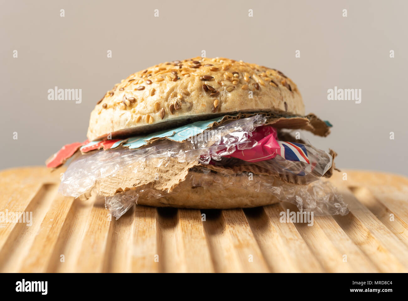 Fresh tasty burger with plastic waste and paper cardboard inside on ...