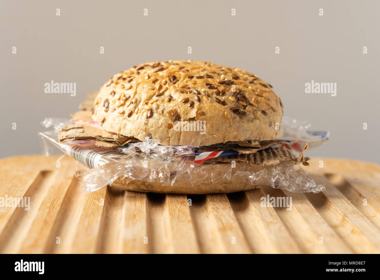 Fresh tasty burger with plastic waste and paper cardboard inside on ...