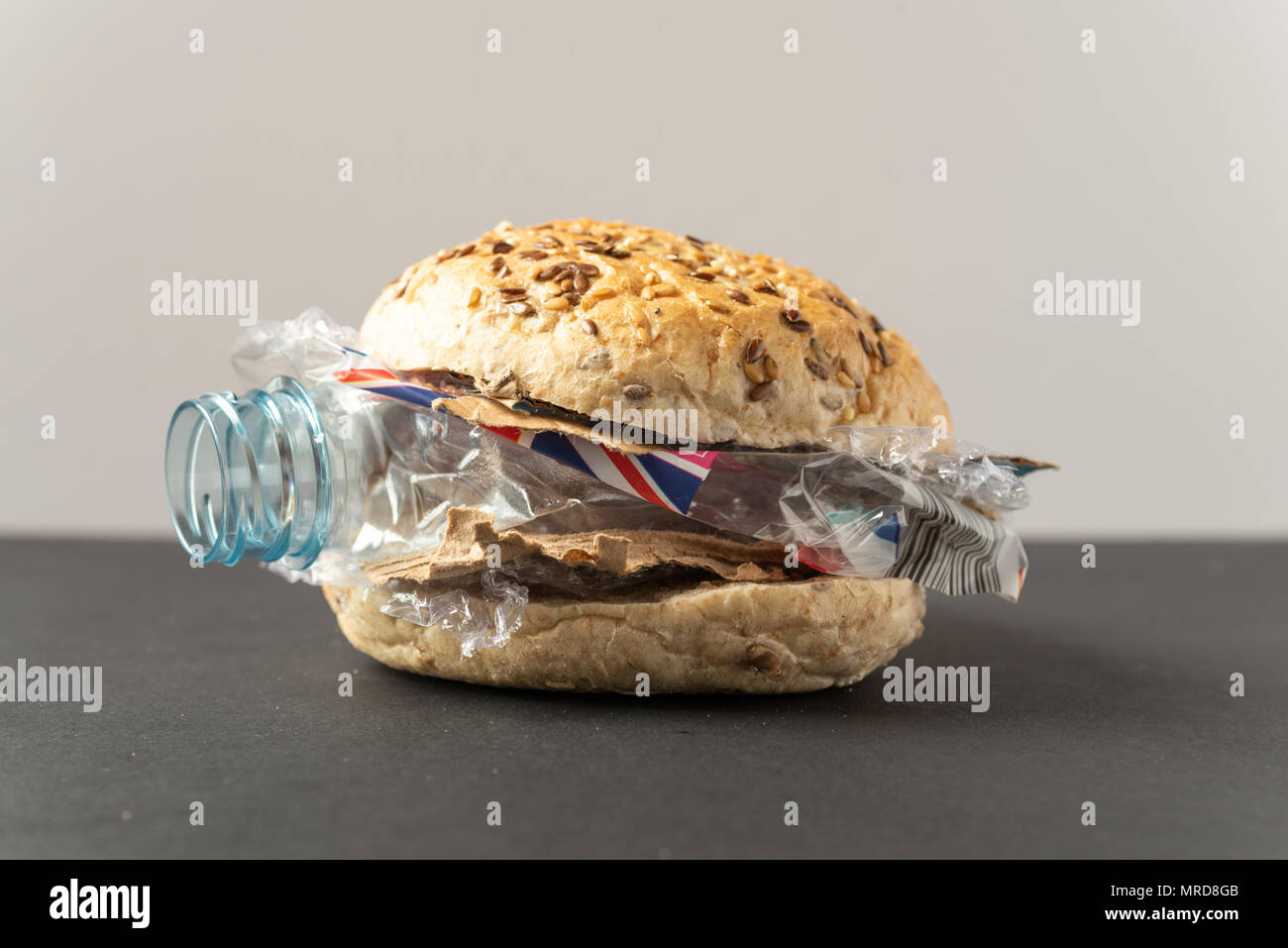 Fresh tasty burger with plastic waste and paper cardboard inside on ...