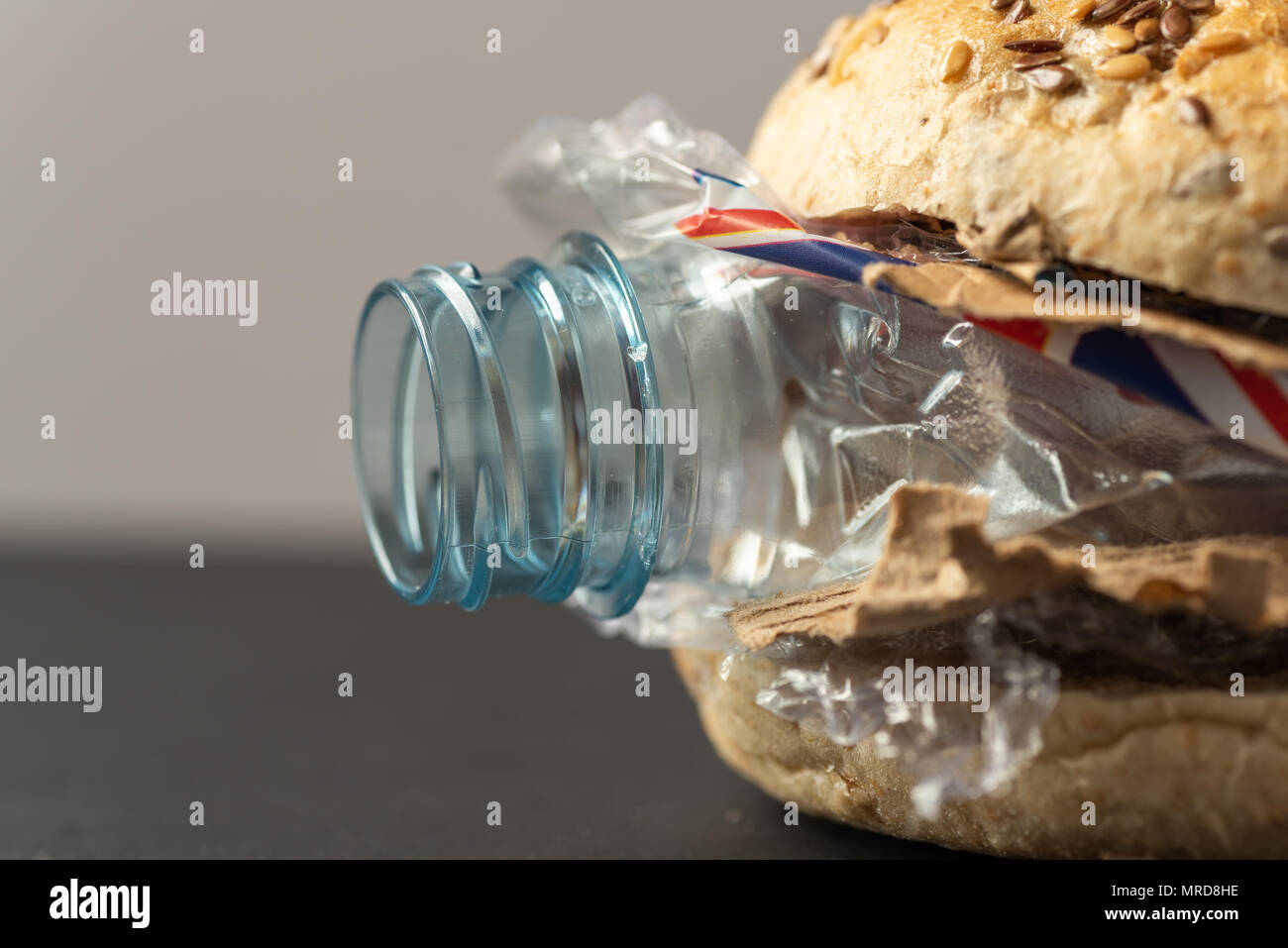 Fresh tasty burger with plastic waste and paper cardboard inside on ...