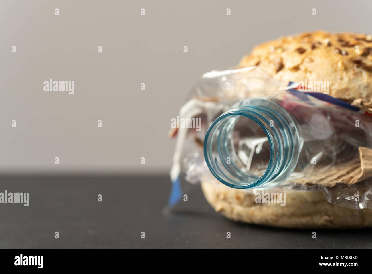 Fresh tasty burger with plastic waste and paper cardboard inside on ...