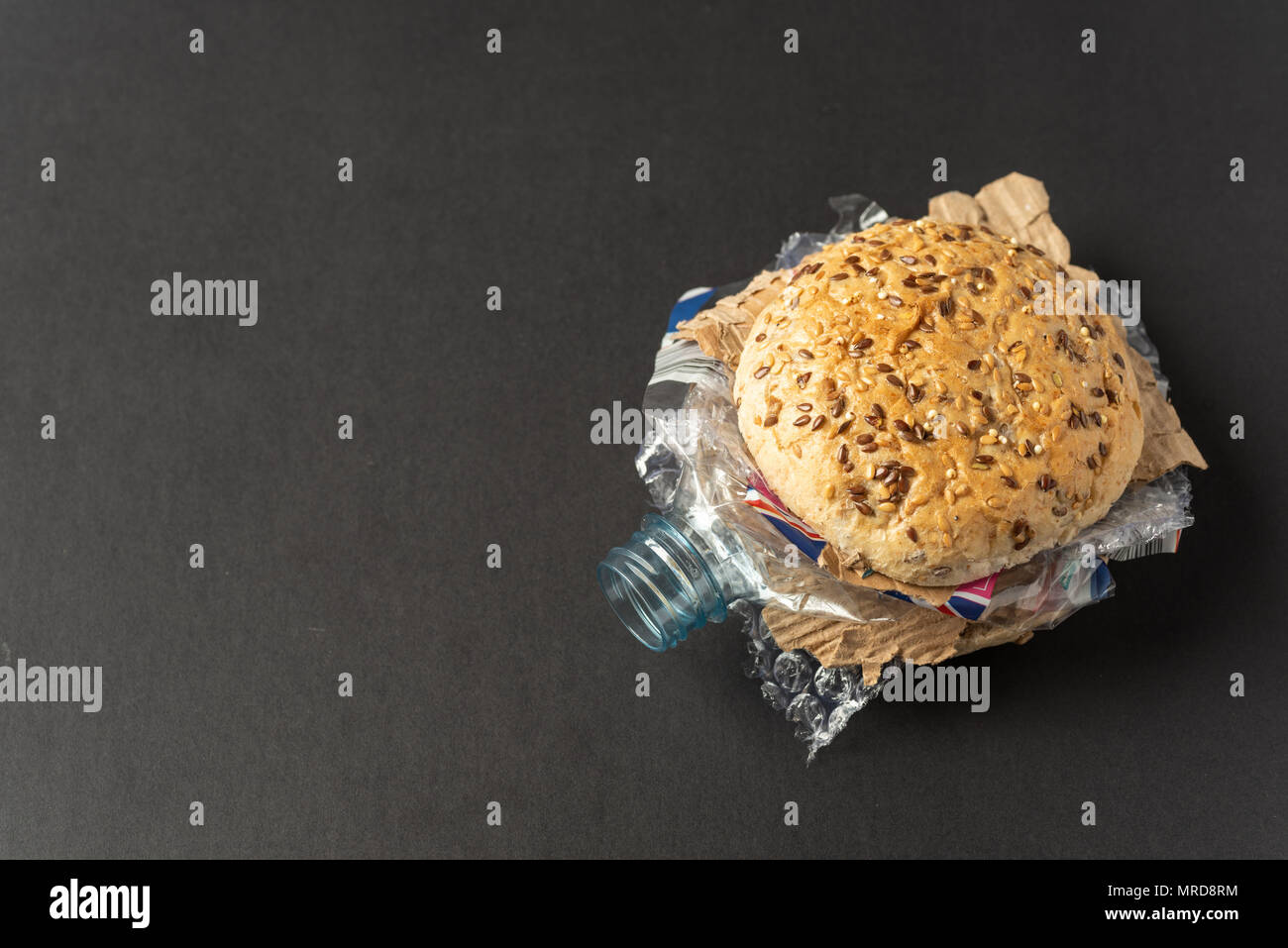 Fresh tasty burger with plastic waste and paper cardboard inside on ...
