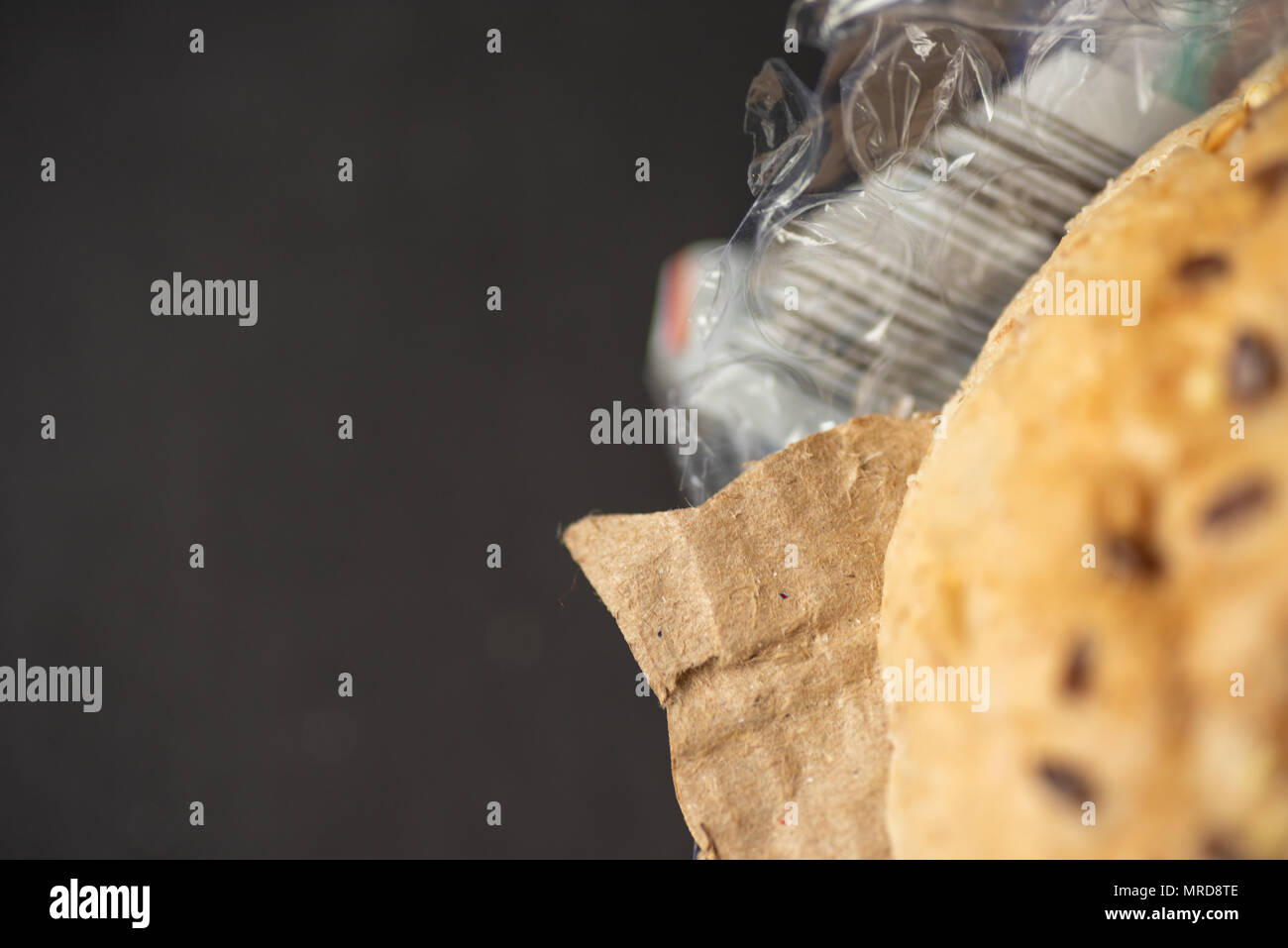 Fresh tasty burger with plastic waste and paper cardboard inside on ...