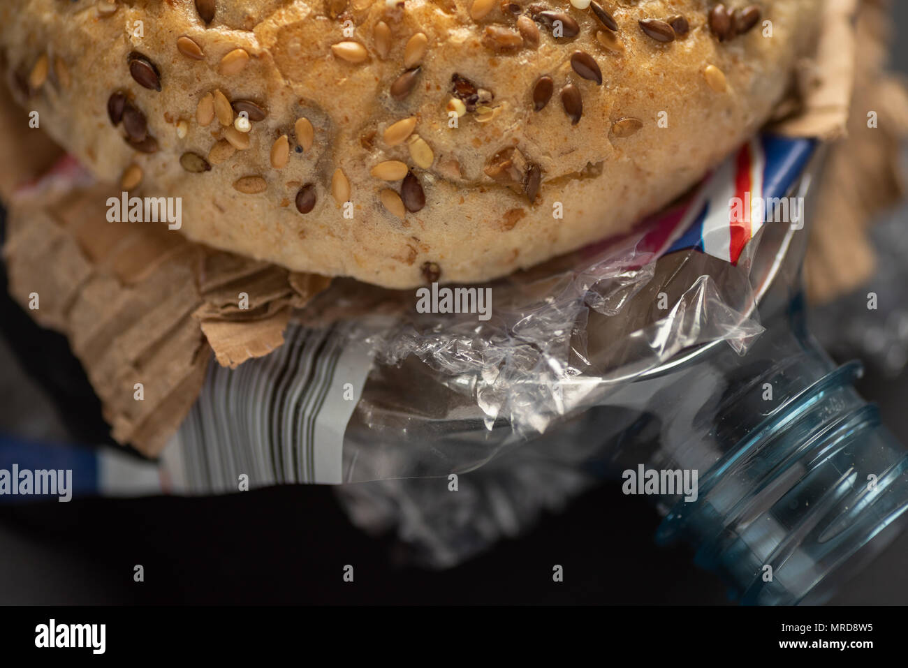 Fresh tasty burger with plastic waste and paper cardboard inside on ...