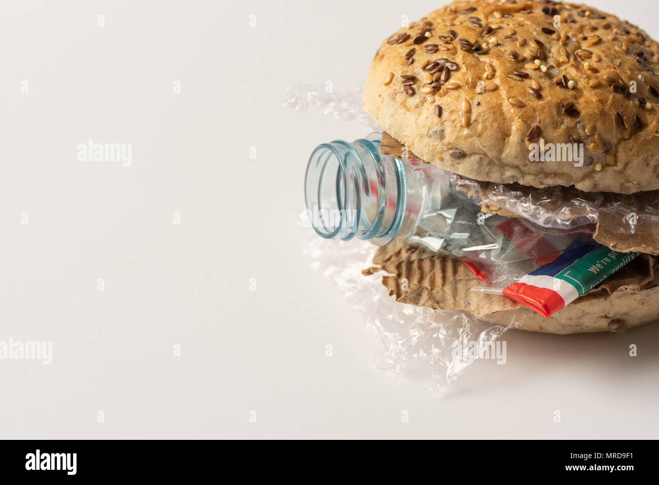 Fresh tasty burger with plastic waste and paper cardboard inside on ...