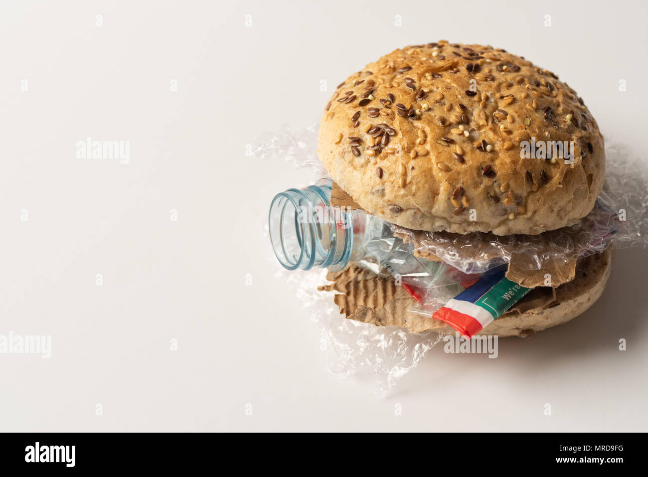 Fresh tasty burger with plastic waste and paper cardboard inside on ...