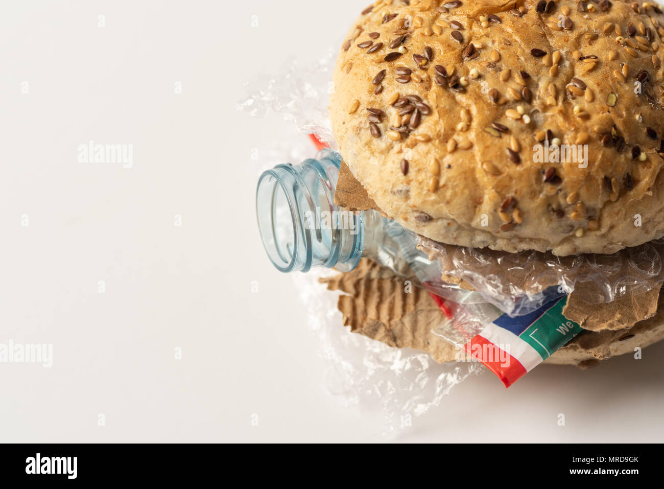 Fresh tasty burger with plastic waste and paper cardboard inside on ...