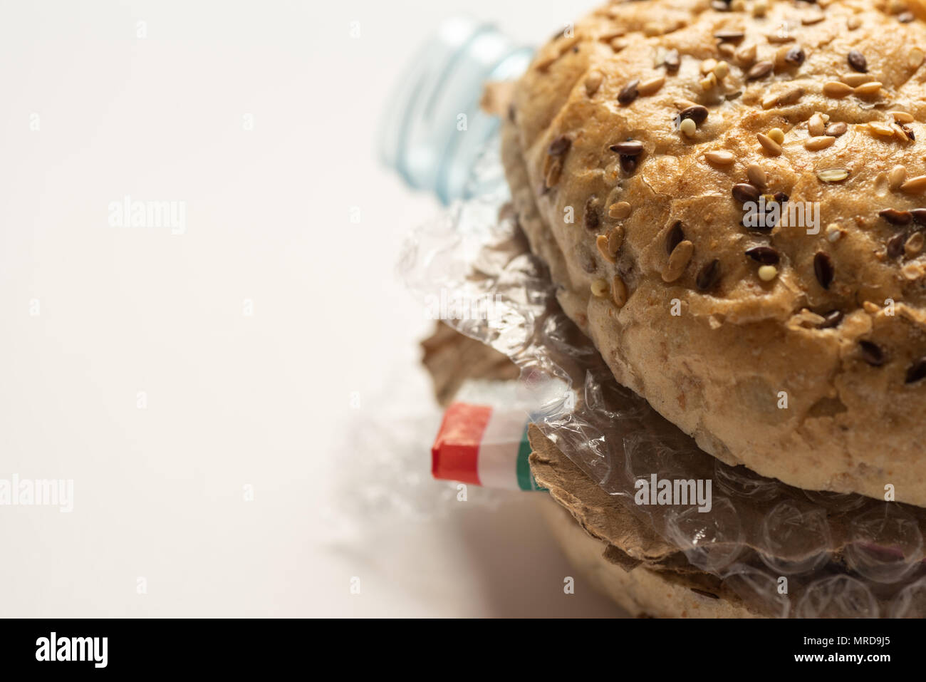 Fresh tasty burger with plastic waste and paper cardboard inside on ...