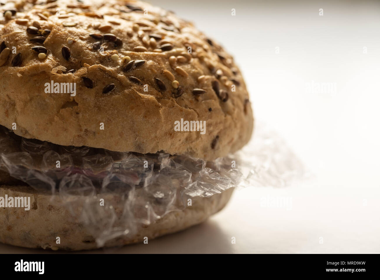 Fresh tasty burger with plastic waste and paper cardboard inside on ...