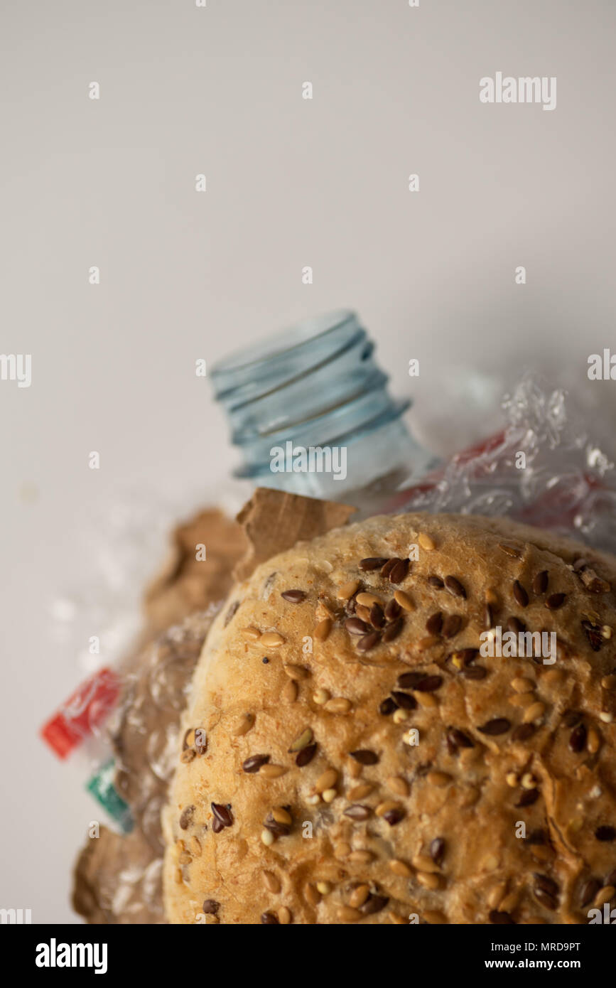 Fresh tasty burger with plastic waste and paper cardboard inside on ...