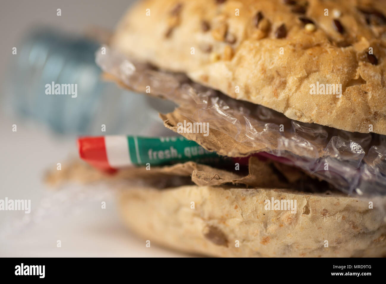 Fresh tasty burger with plastic waste and paper cardboard inside on ...