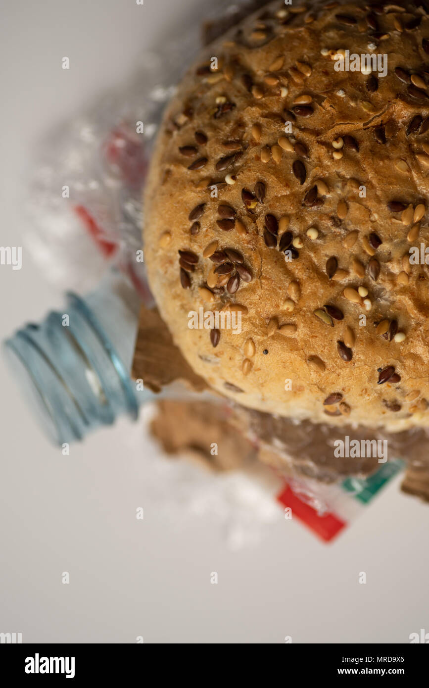 Fresh tasty burger with plastic waste and paper cardboard inside on ...