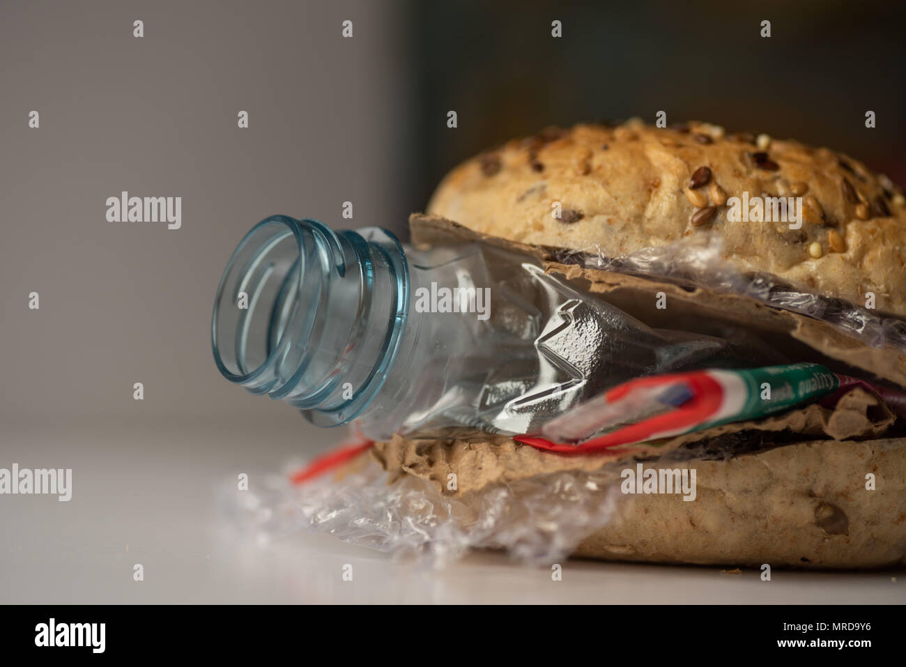 Fresh tasty burger with plastic waste and paper cardboard inside on ...
