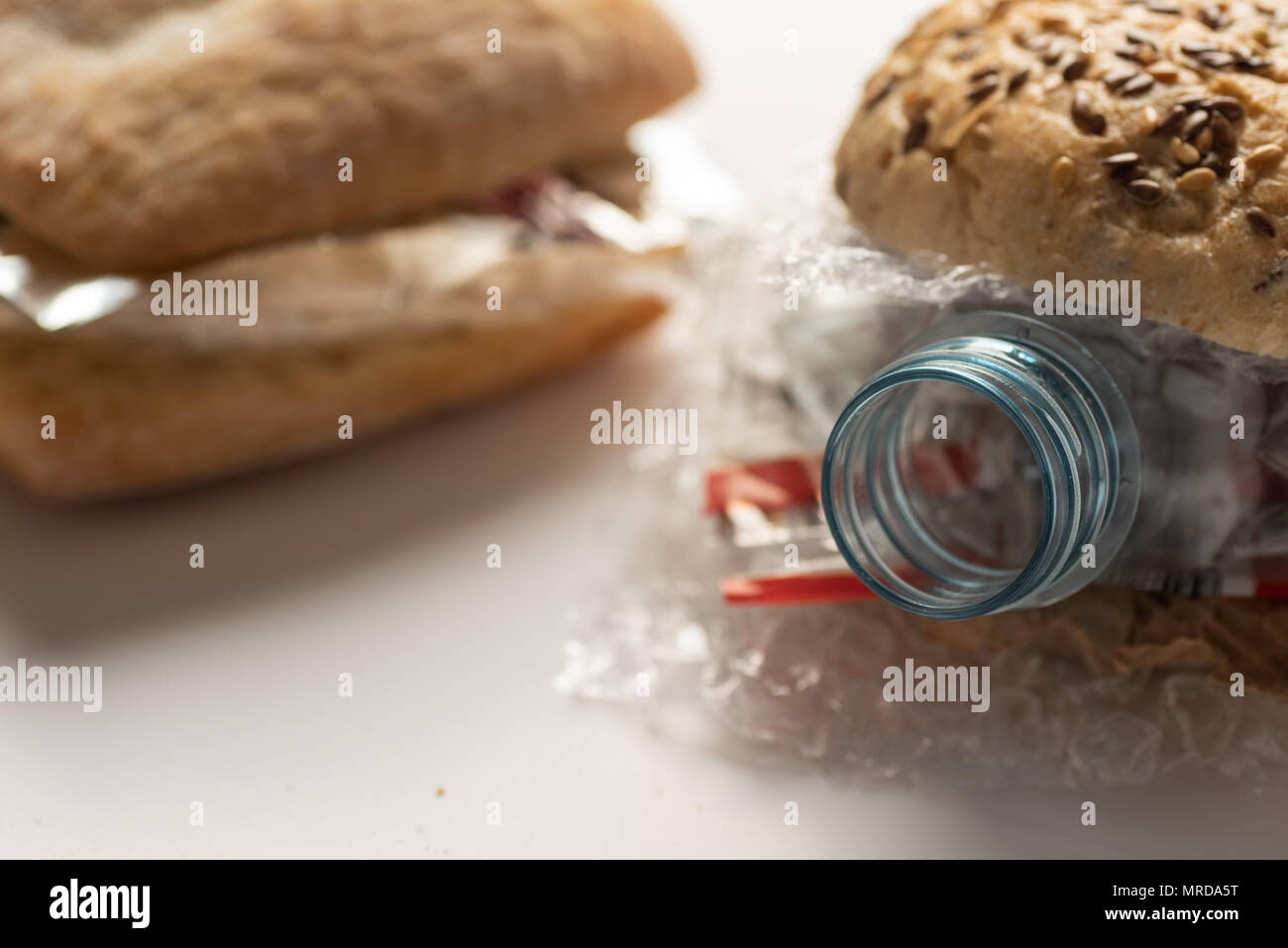 Fresh tasty burger with plastic waste and paper cardboard inside on ...