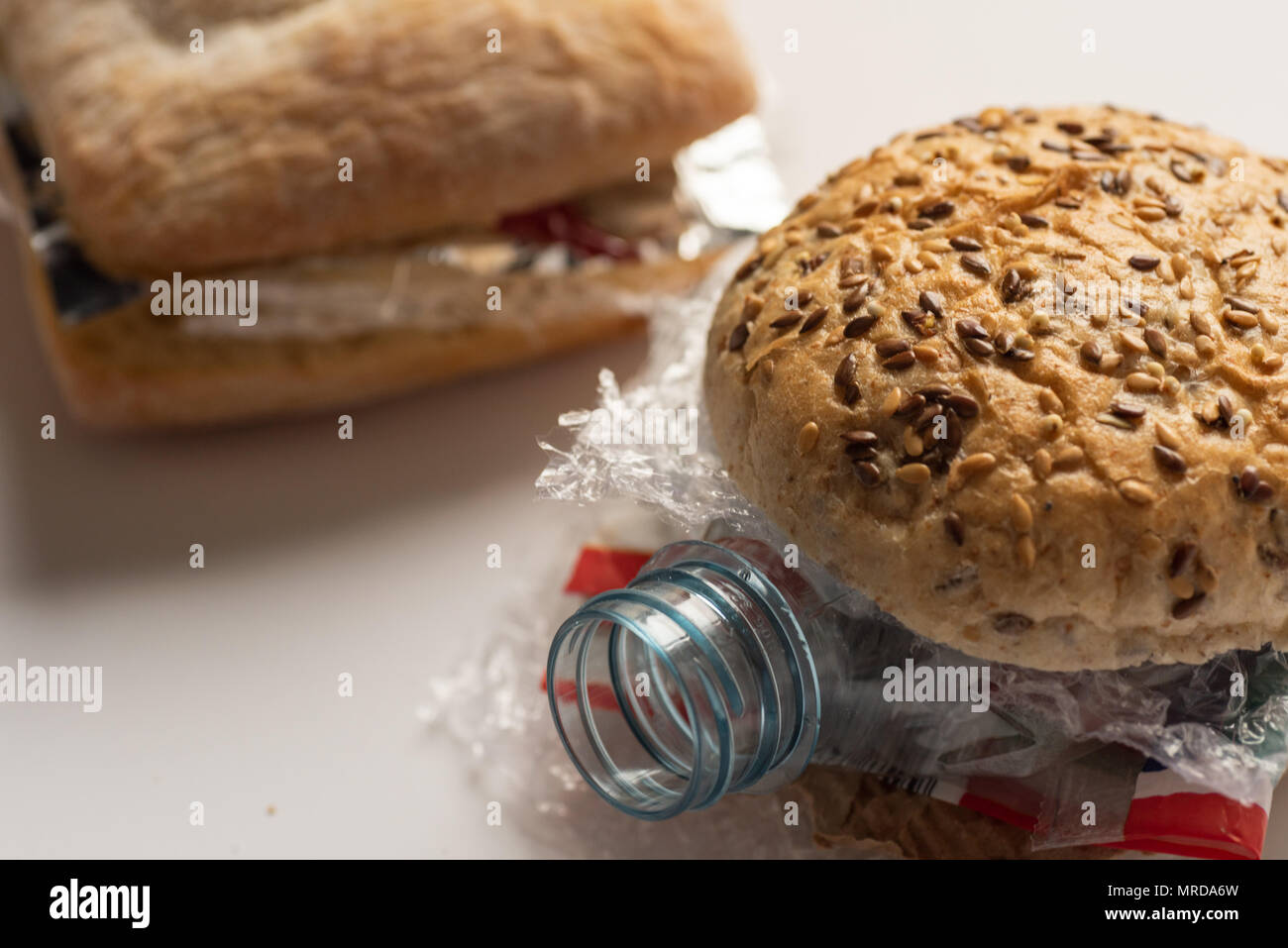 Fresh tasty burger with plastic waste and paper cardboard inside on ...