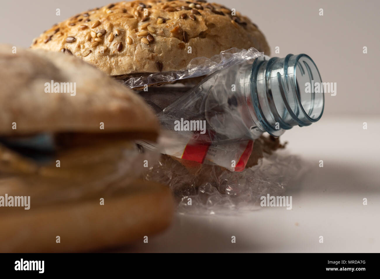 Fresh tasty burger with plastic waste and paper cardboard inside on ...