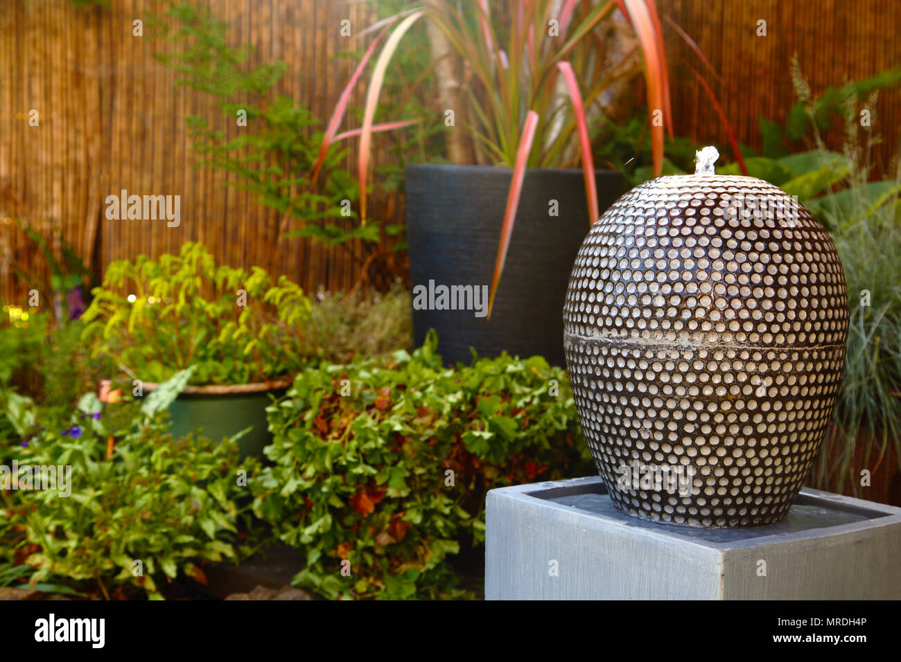 Fountain water feature in a garden yard with running water Stock Photo ...