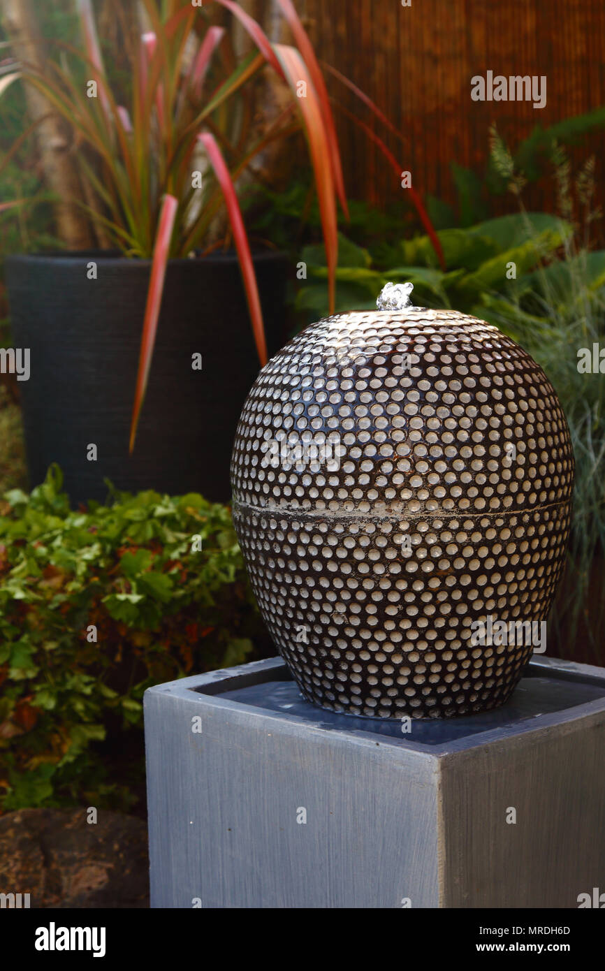 Fountain water feature in a garden yard with running water Stock Photo ...