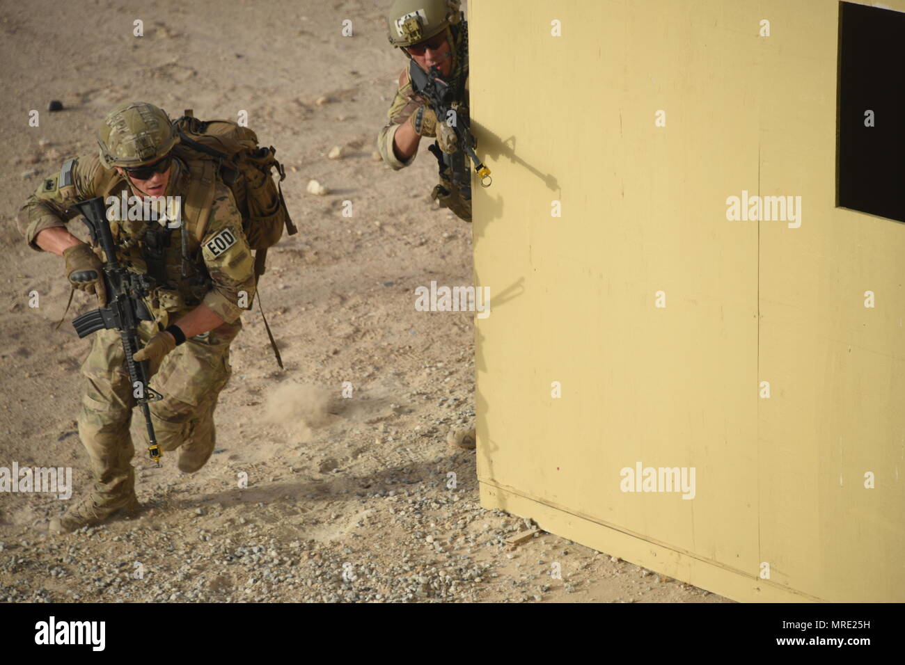 An Air Force explosive ordnance disposal technician runs to another ...