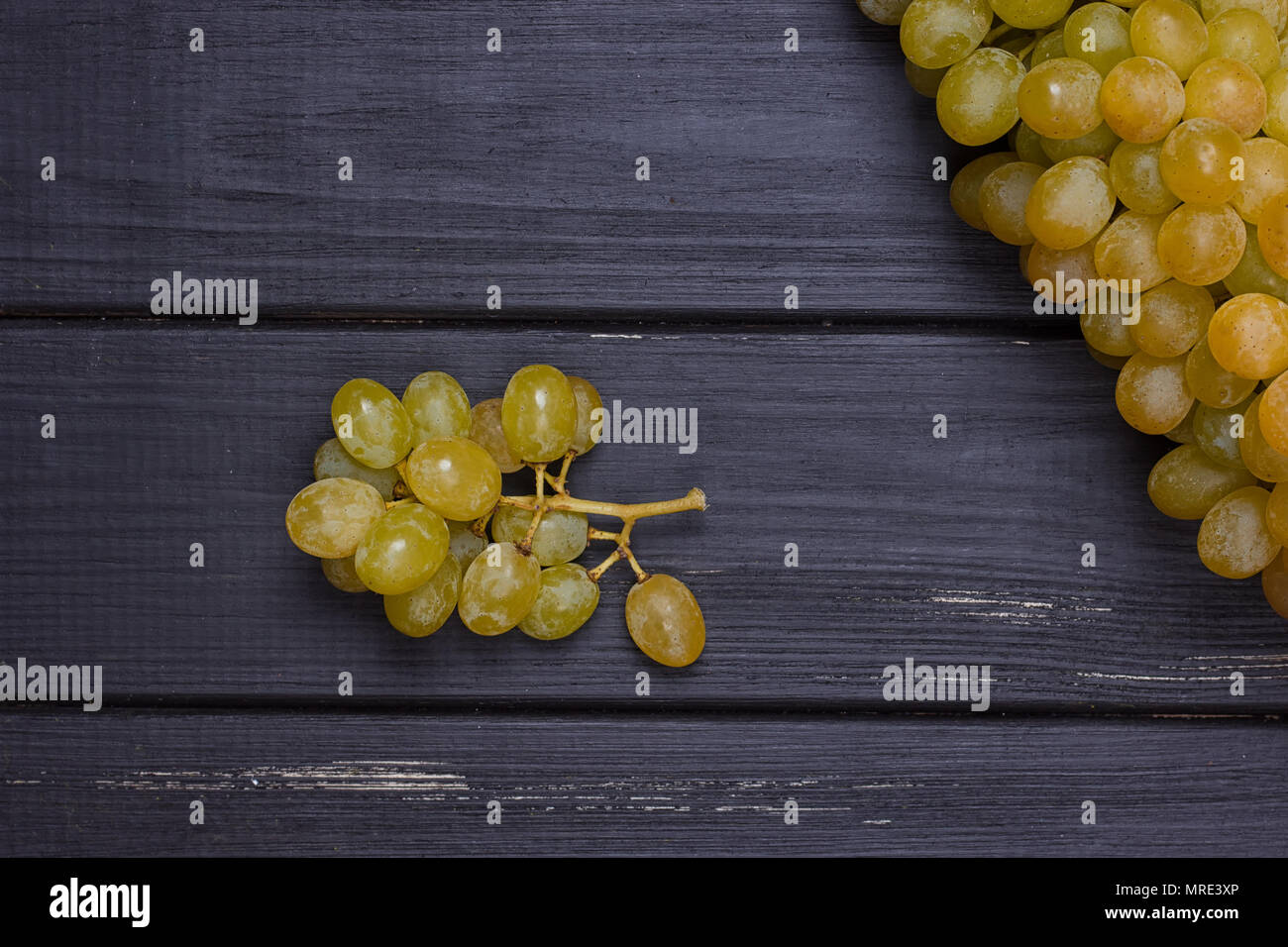 bunch of white grapes on a black wooden background. Rustic style Stock ...