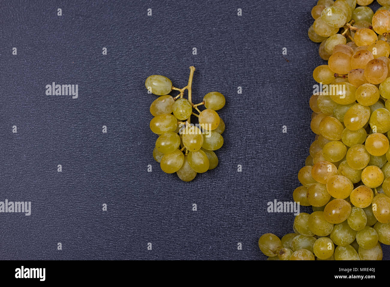 Large grapes cluster amber color on black background. copy-space Stock ...