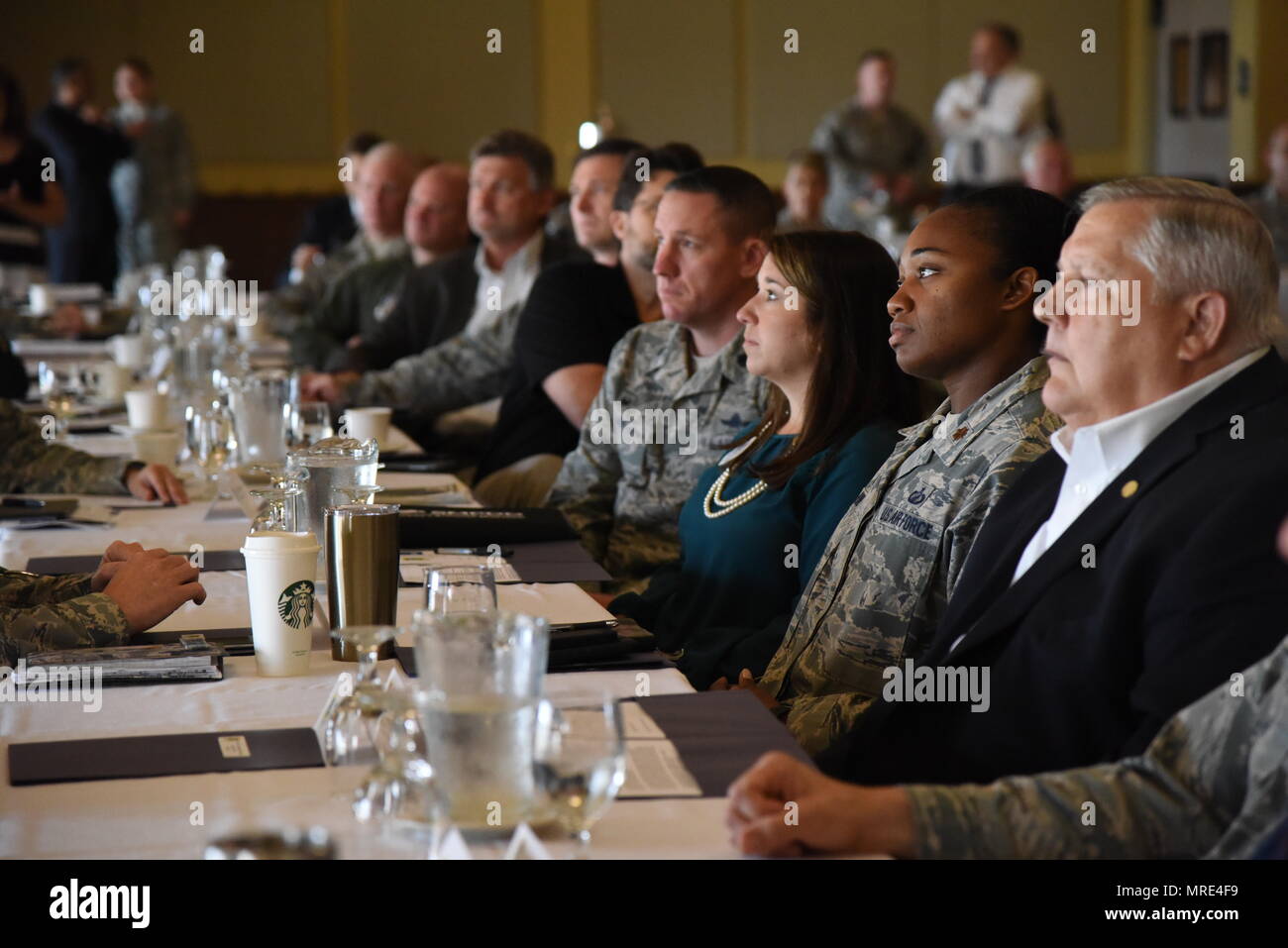 Military and civic leaders watch a promotional video during the Air ...