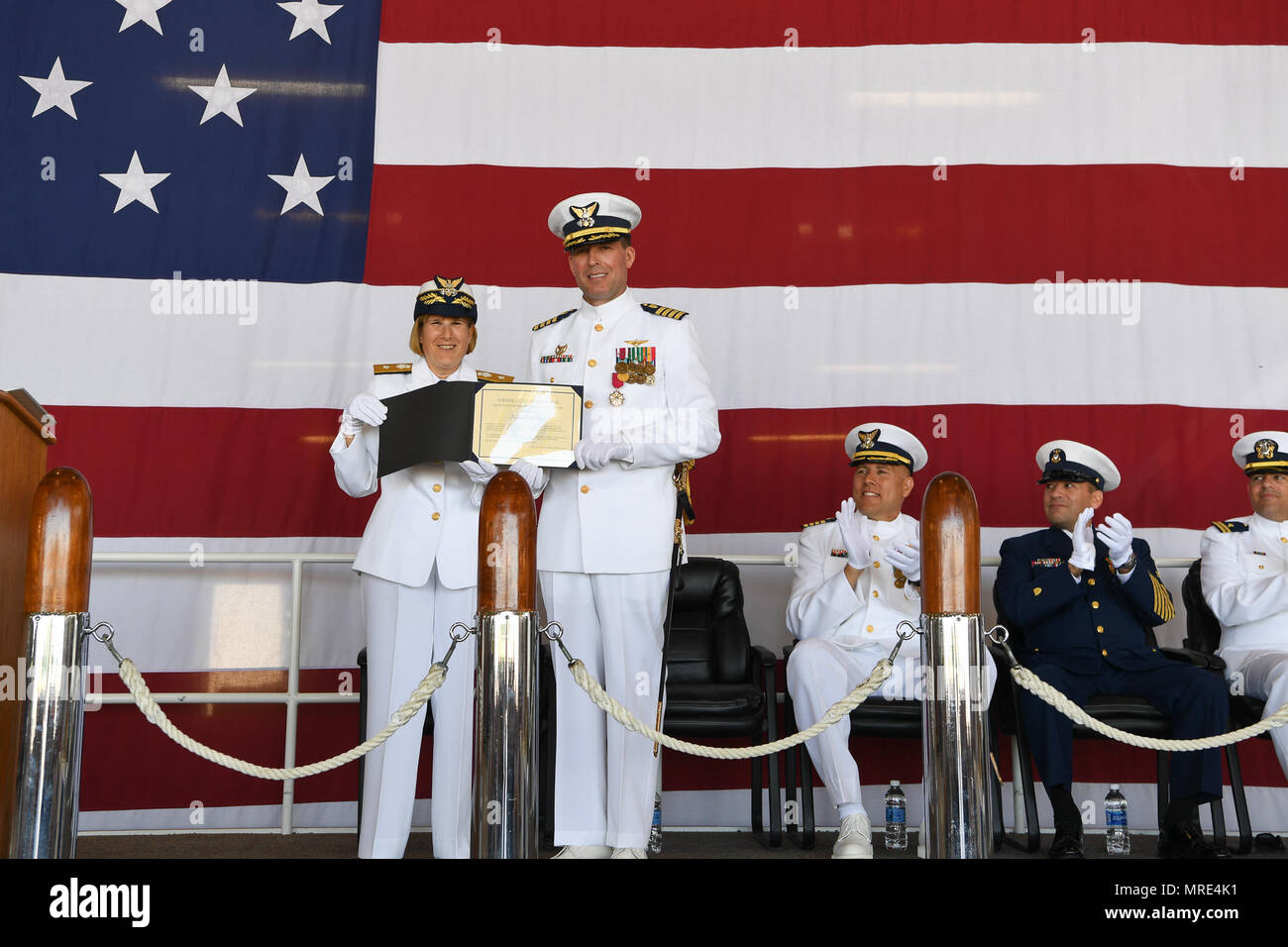 Coast Guard Rear Adm. Meredith Austin presents Capt. Richard Craig with ...