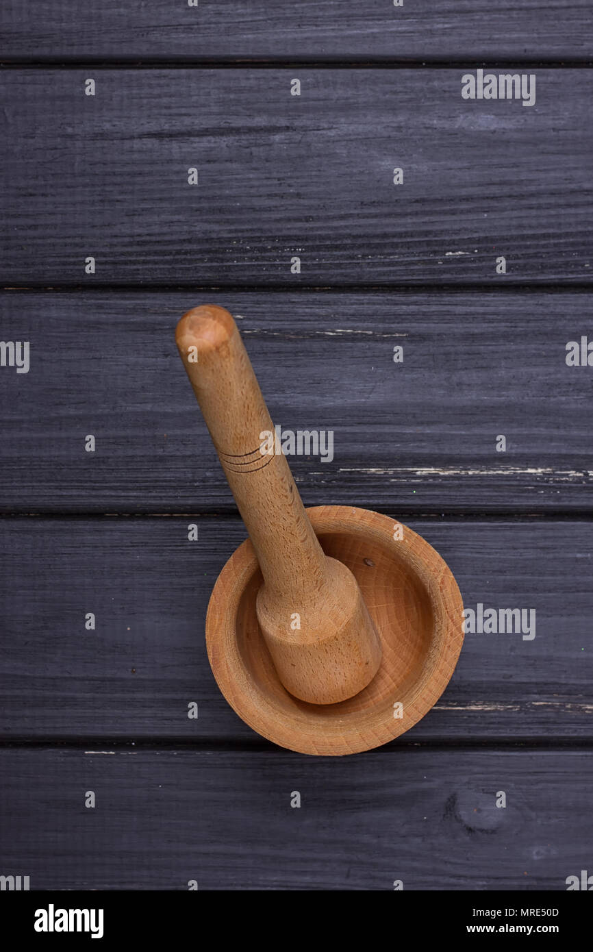 Handmade wooden mortar on the black background Stock Photo - Alamy