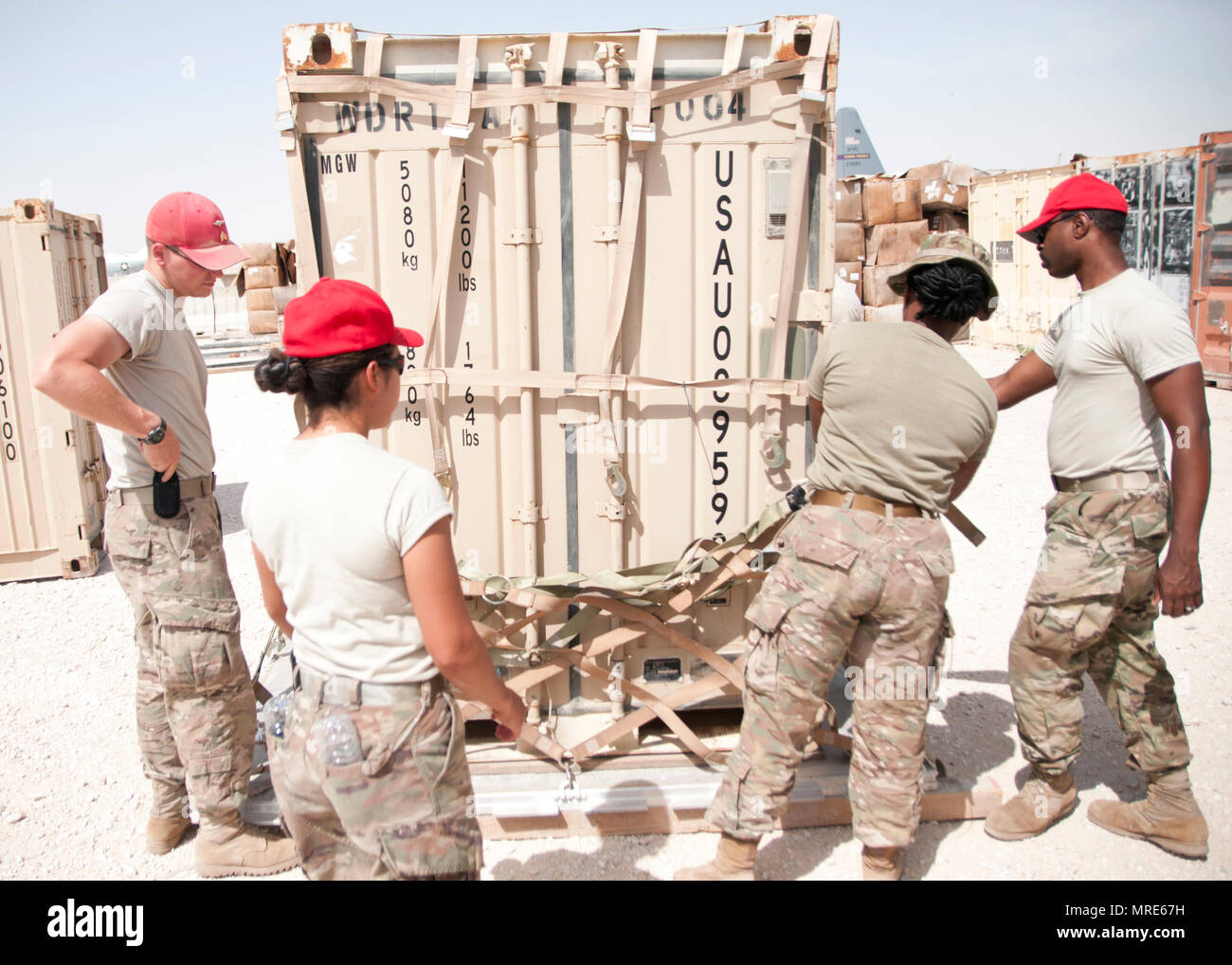 Soldiers of the 824th Quartermaster Company secure a container with ...