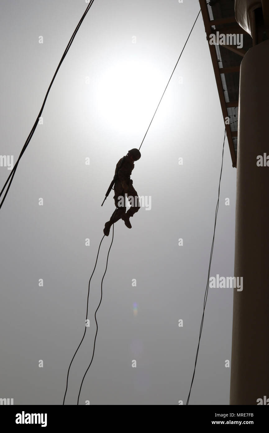 A U.S. Servicemember navigates the rappel tower during day eight of U.S ...