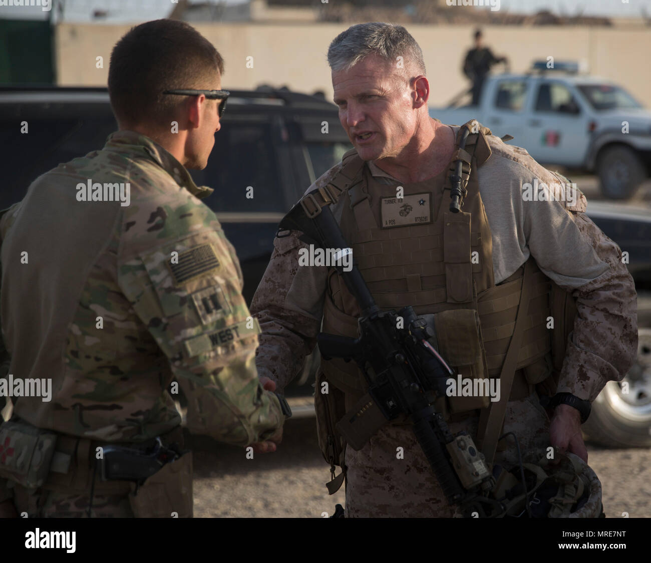A U.S. Army infantry officer with Task Force Iron, left, thanks Brig ...