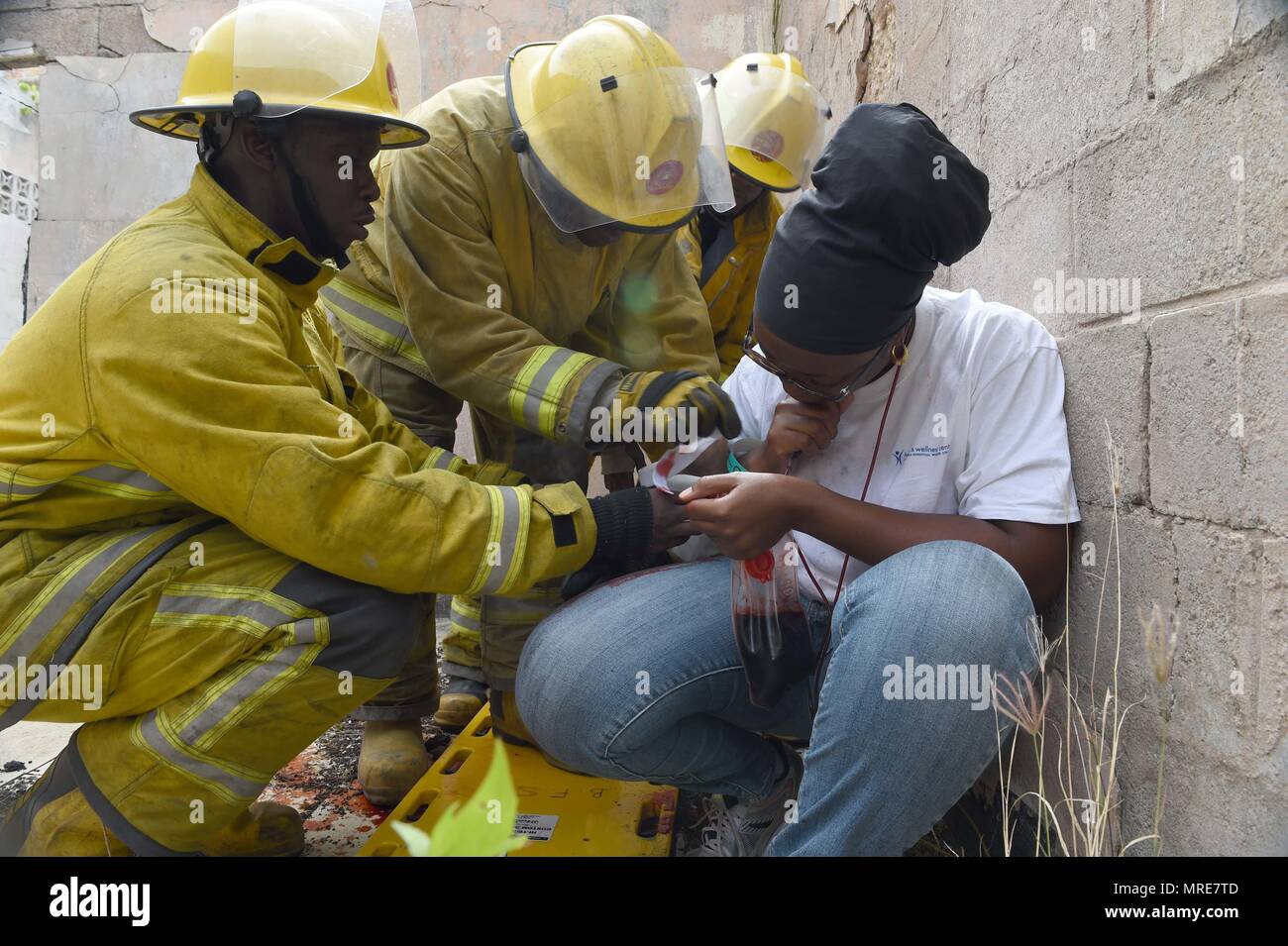 Fire officers from the Bridgetown Fire Department assess and assist a ...