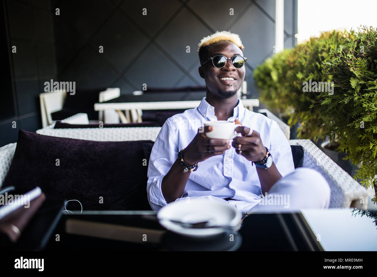 Happy african man drinking coffee at cafe at summer day Stock Photo - Alamy