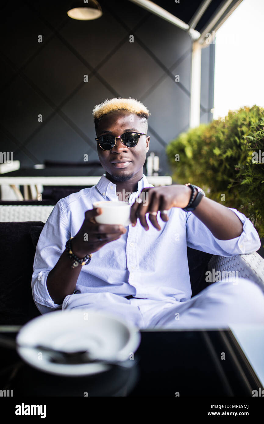 Happy african man drinking coffee at cafe at summer day Stock Photo - Alamy