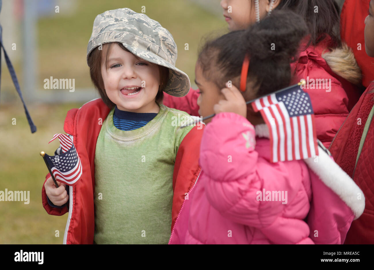 Children hold an American flag during Yoiko Child Development Center ...