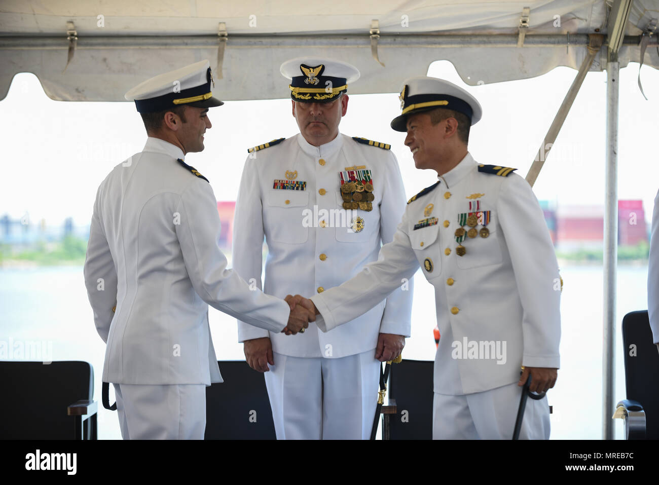 Coast Guard Lt. Kristopher Valdez (left) shakes hands with Lt. Jonathan ...