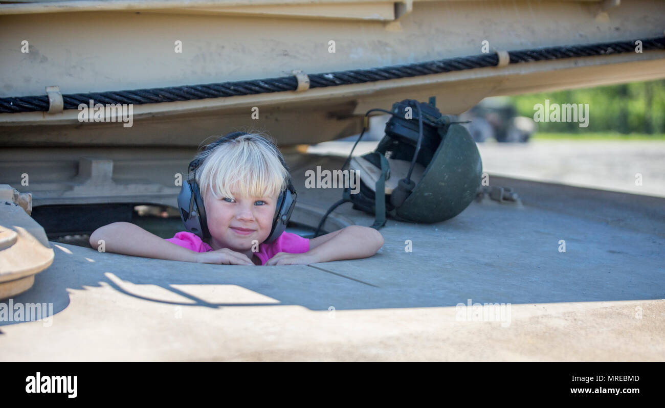 A girl tours the driver compartment of an M1A1 Abrams tank at Camp ...