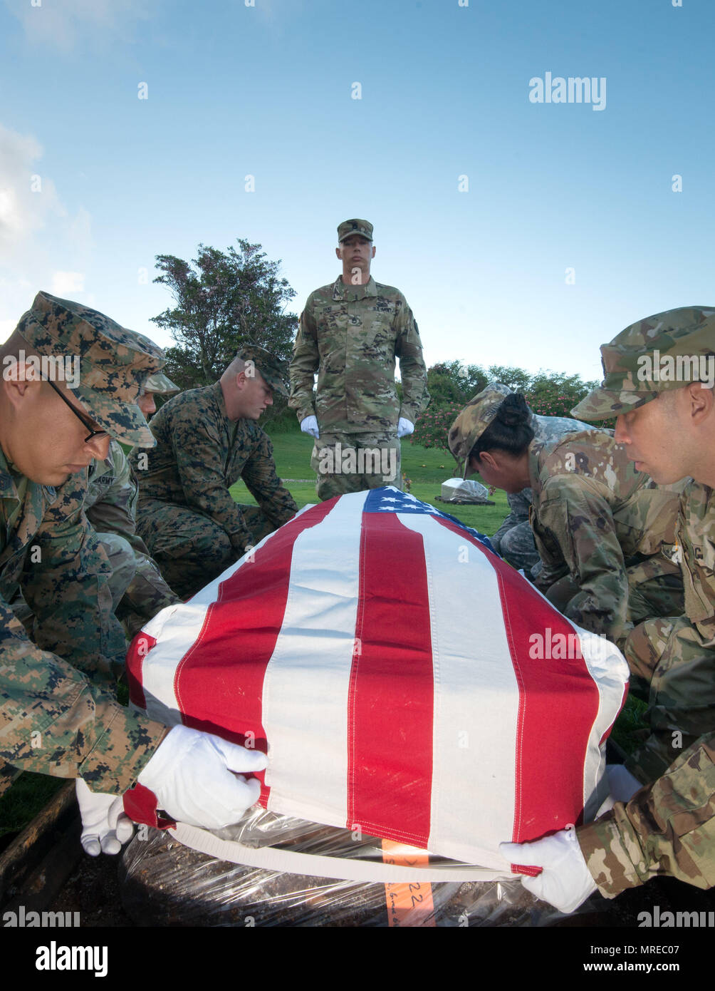 Defense POW/MIA Accounting Agency (DPAA) drapes the U.S. flag over a ...