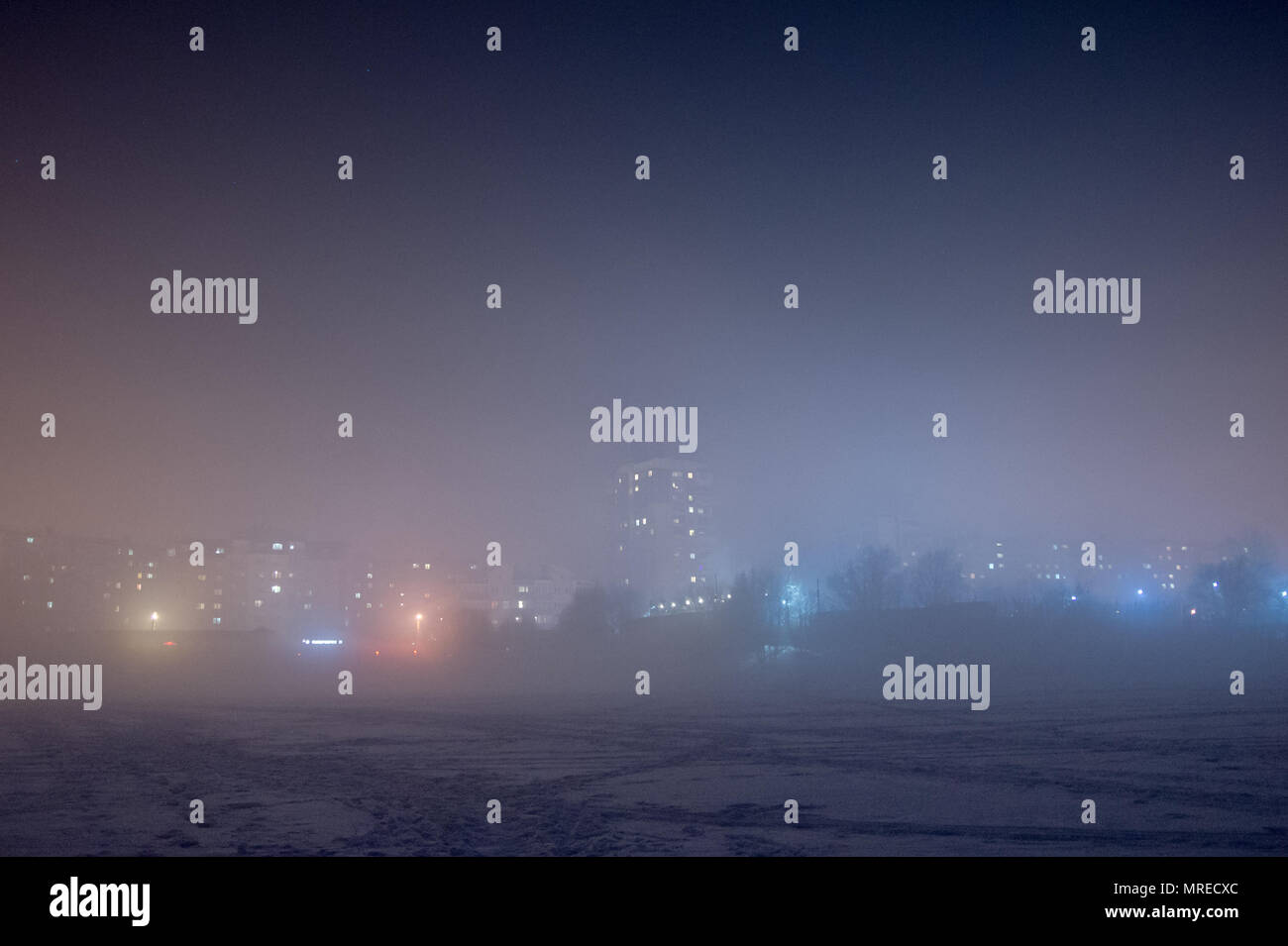 A winter evening city in a fog. Landscape Stock Photo - Alamy