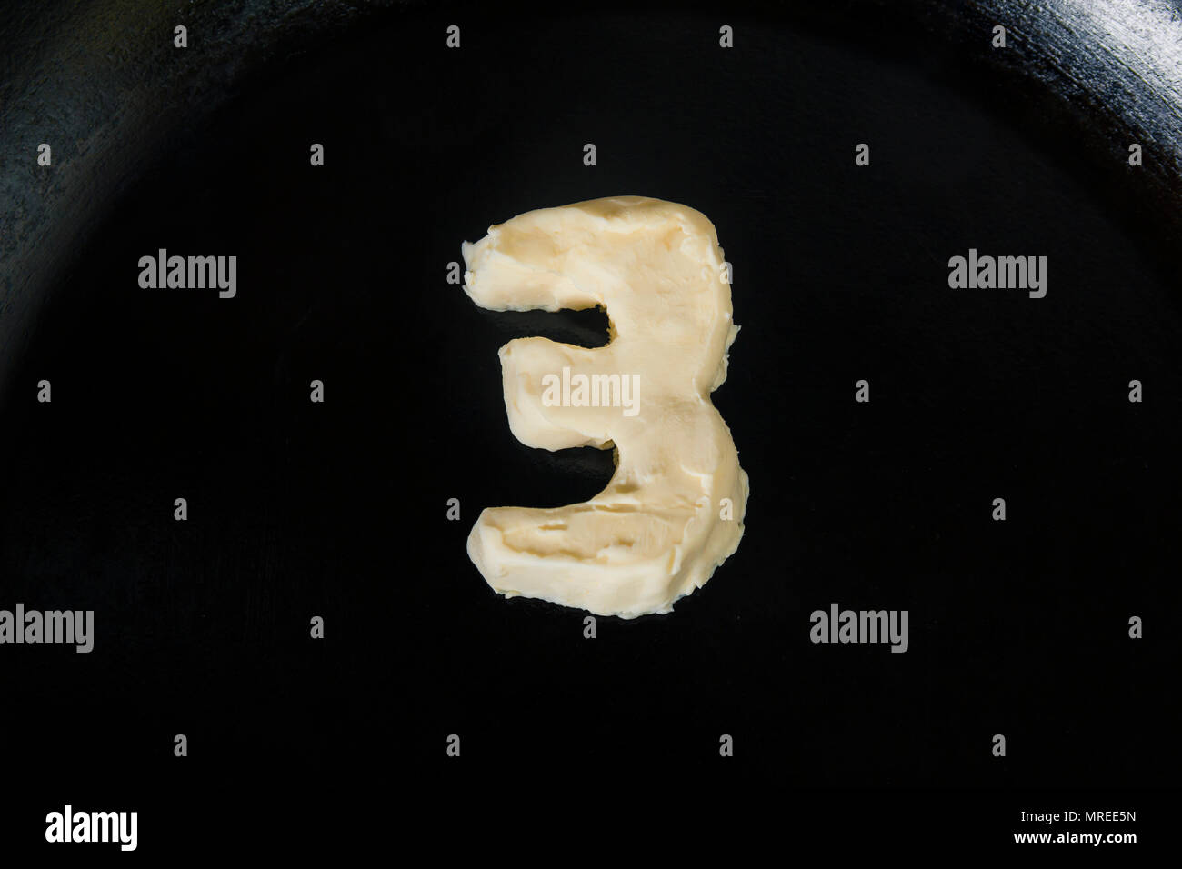 Butter in shape of number 3 on hot pan - Close up top view Stock Photo ...