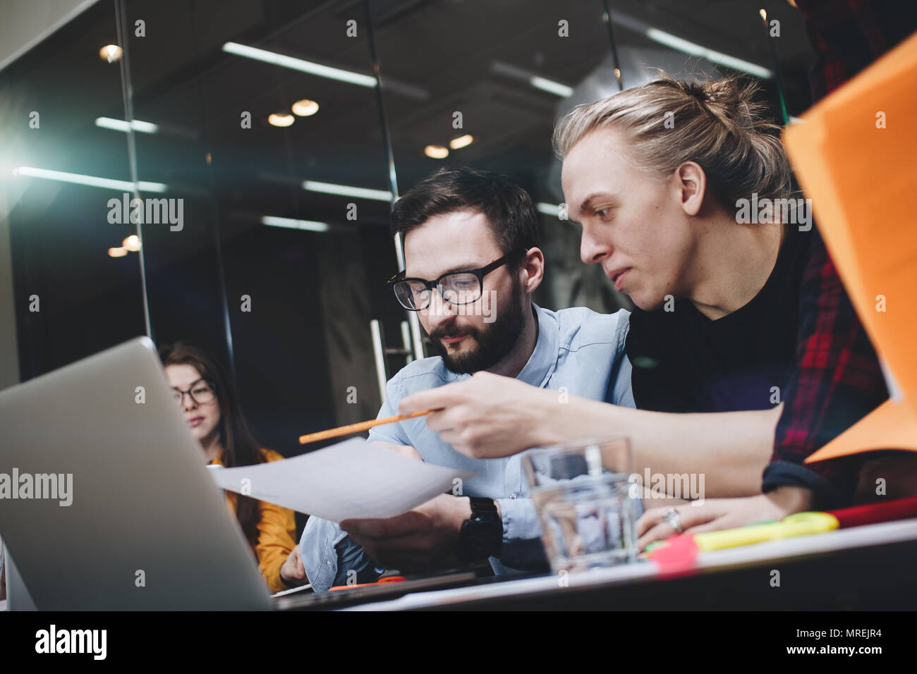 Team of young engineering students is working on a new project ...