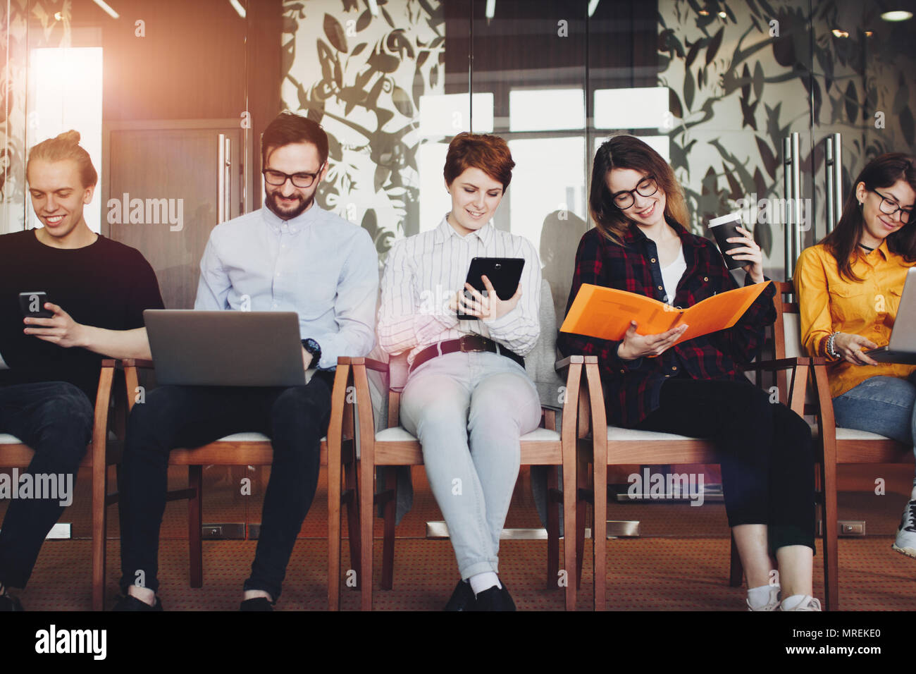 Young business crew in big modern loft office. Young office workers ...