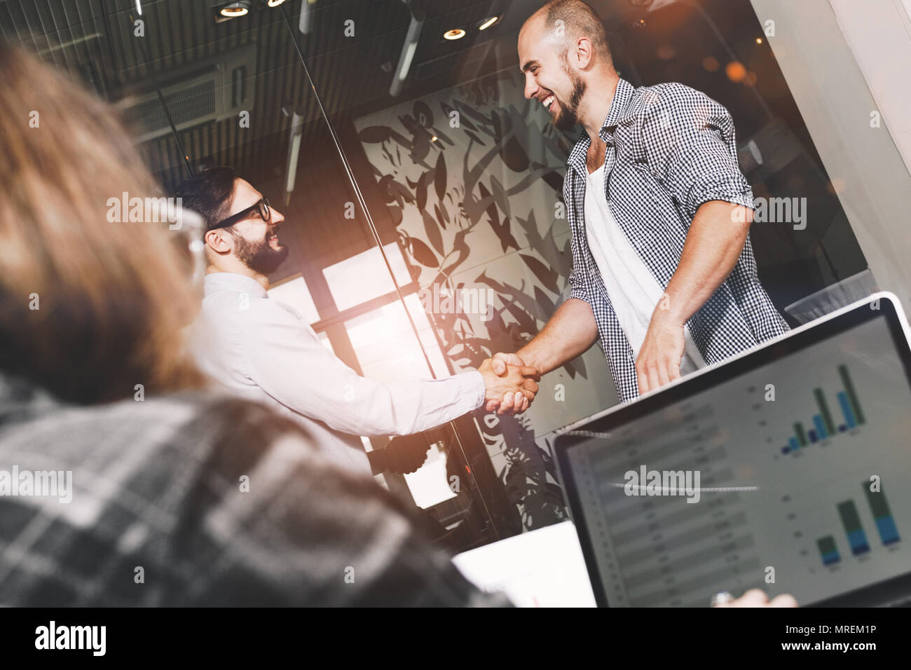 Group of young and modern businessmen have made deal and make handshake ...