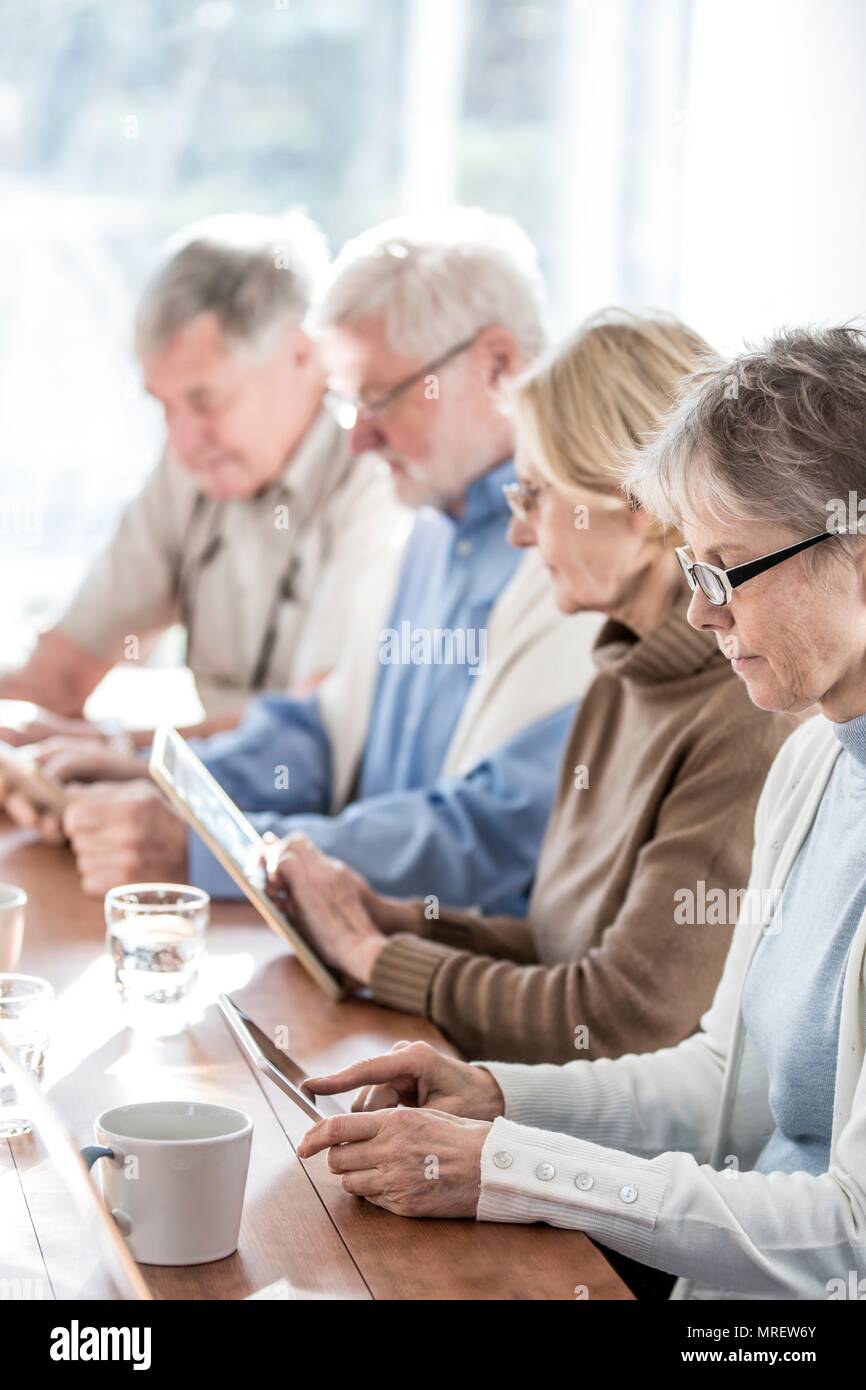 Senior adults in care home using digital tablets Stock Photo - Alamy