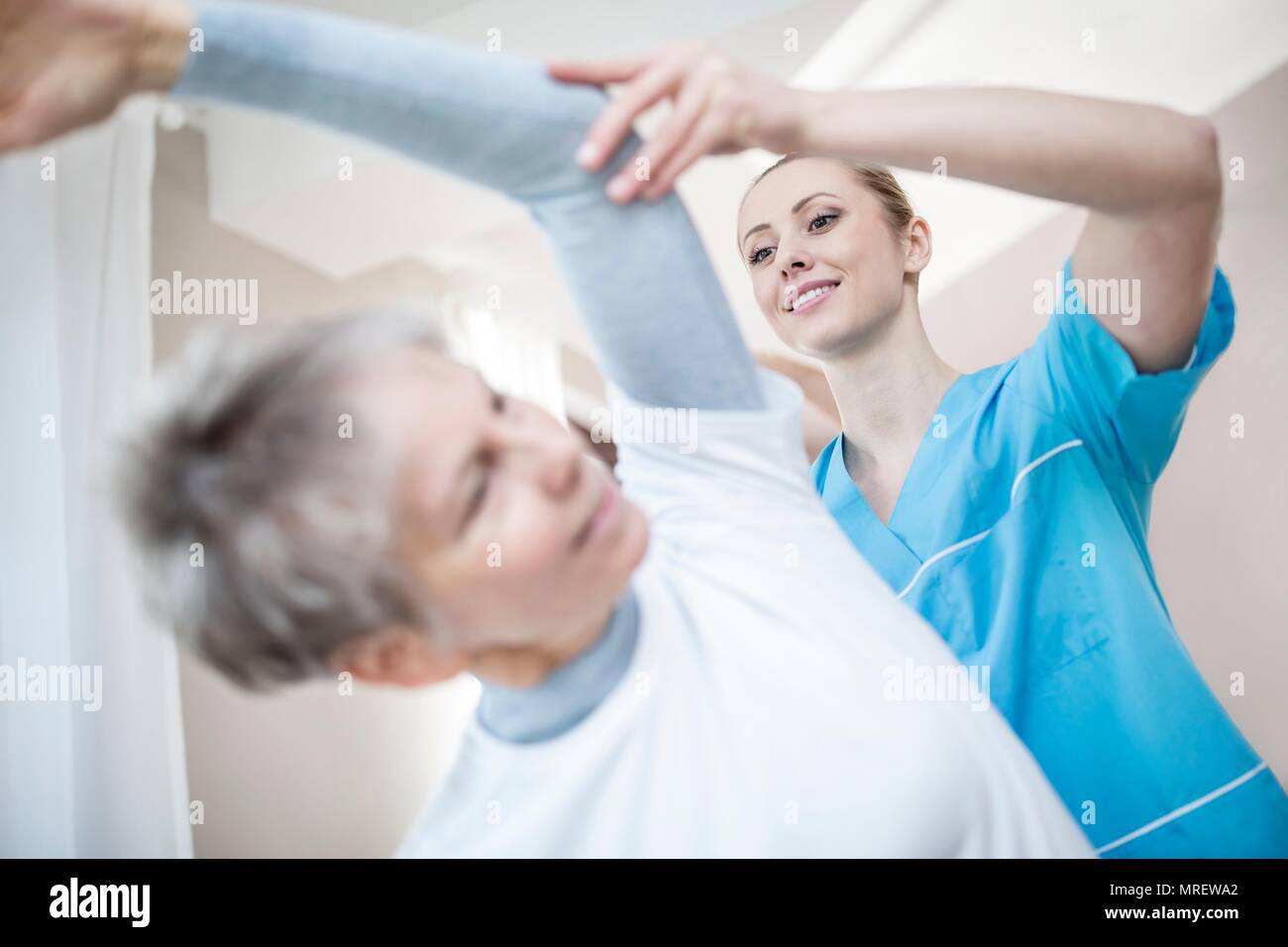 Nurse bending hi-res stock photography and images - Alamy