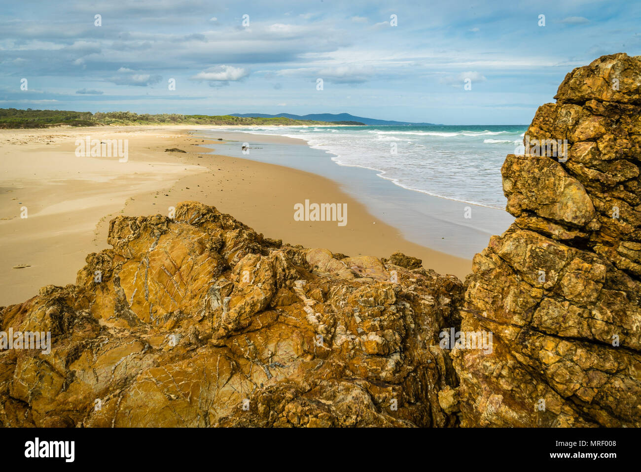 Volcanic stones on the beach in Australia Stock Photo - Alamy