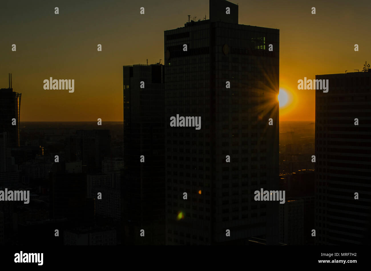Silhouette of buildings against sunset backdrop hi-res stock ...