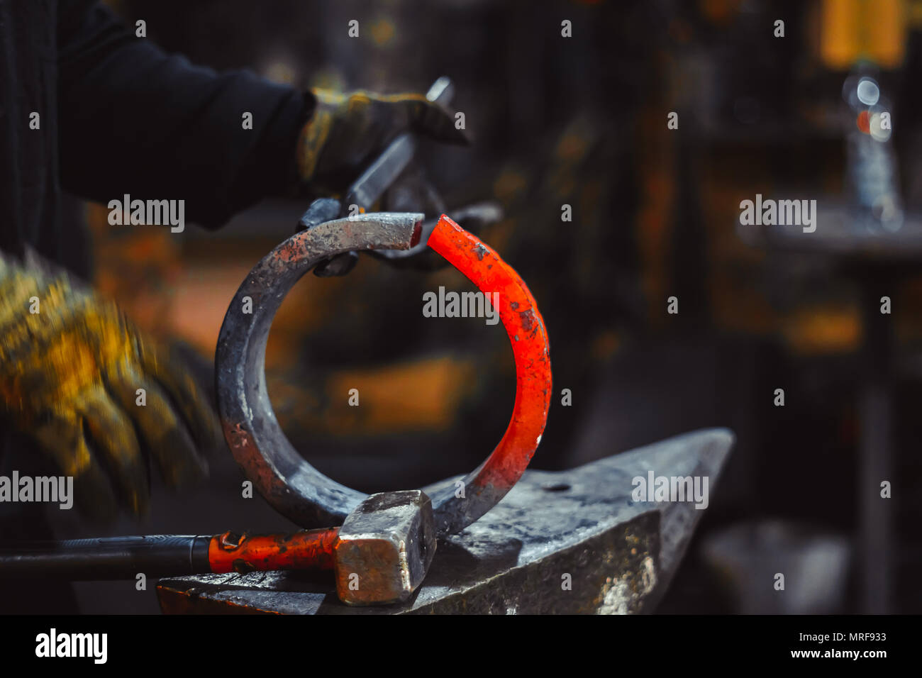 Blacksmith working on metal on anvil at forge high speed detail shot ...